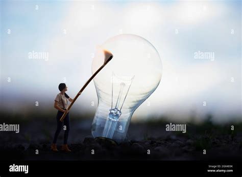 Woman Tries To Light A Light Bulb With A Match Concept Of Idea And Innovation Stock Photo Alamy