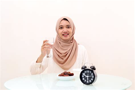 젊은 아시아 무슬림 여성이 금식을 깨기 위해 물 한 잔을 들고 있다 라마단 개념 25 29세에 대한 스톡 사진 및 기타 이미지 25 29세 Eid Ul Fitr 개념