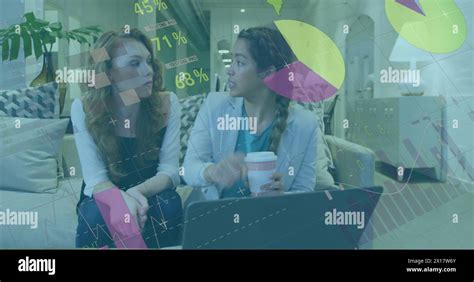 Image Of Statistical Data Processing Against Two Diverse Women Discussing Over Laptop At Office