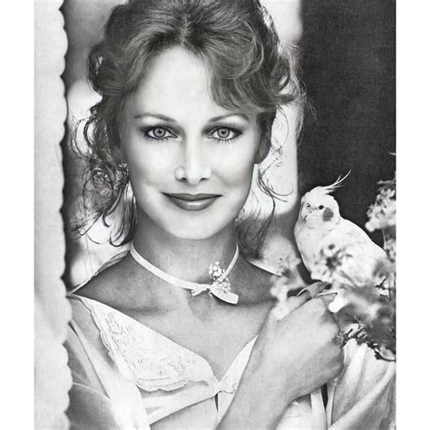 A Black And White Photo Of A Woman Holding A Bird