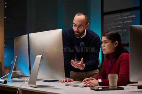 Two People Using Computers And Coding With Blue Lights Stock Image