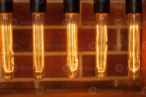 Light Bulb Lamp On Dark Red Brick Background With Hotspot Close Up Loft Stock Photo At