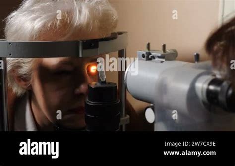 Ophthalmologist Checking Eyesight Of Senior Woman With Modern Equipment