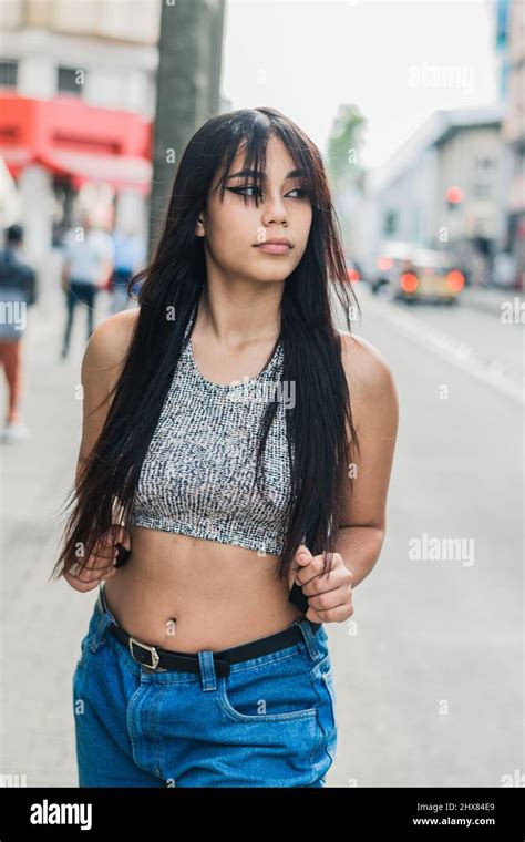 Beautiful Latina Girl With Brown Skin Walking Down The Street In The