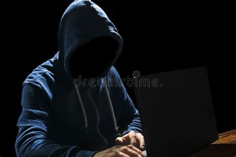 Hacker With Computer Man Sitting At A Table In A Hood Stock Image