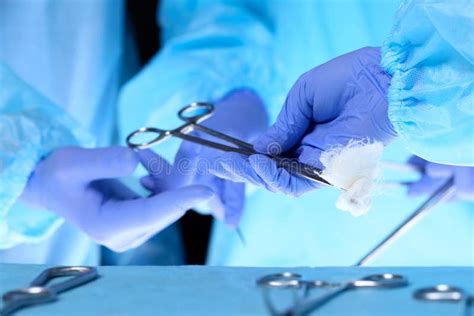 Surgeons Hands Holding Surgical Scissors And Passing Surgical Equipment Close Up Health Care