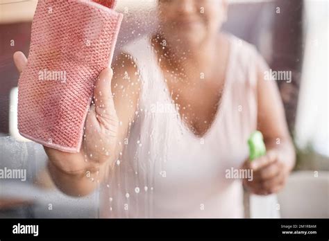 Close Up Background Image Of Senior Woman Cleaning Glass Windows Focus On Hand Holding Wipe