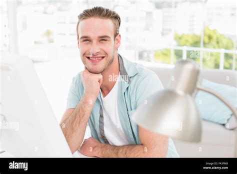 Smiling Man Using Computer At His Desk Stock Photo Alamy