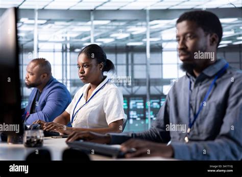 Team Of Programmers In Data Center Running System Diagnostic Tests On Computer To Fix Problems