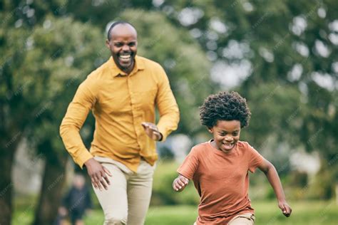 Premium Photo African Father Son And Running In Park Funny Game And
