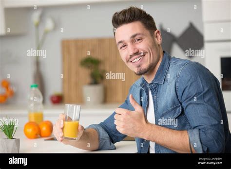 Handsome Man Drinking Orange Juice Stock Photo Alamy