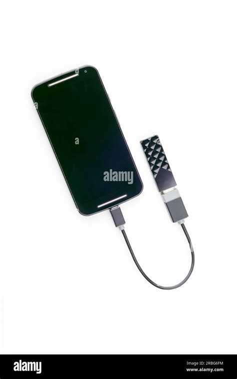 Black Smartphone Connected To A USB Key With An OTG Cable Isolated On White Background Stock