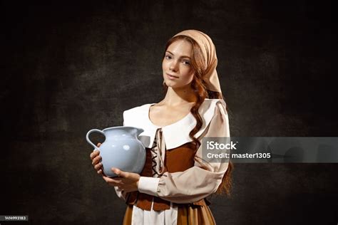 빈티지 스타일 어두운 배경에 고립 된 르네상스 시대의 소녀처럼 긴 곱슬 머리를 가진 젊은 매력적인 빨간 머리 소녀 시대 비교 아름다움 예술 그림 신데렐라에 대한 스톡 사진