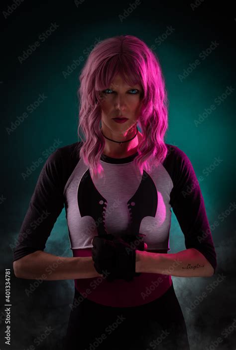 Sexy Female Assassin With Pink Hair Wearing Black Holding Weapons Stock