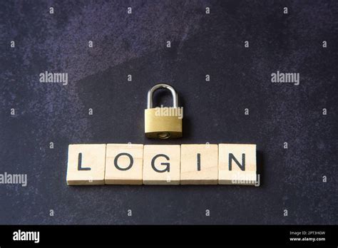 Word Login Written In Wooden Letters Next To A Padlock Representing The Concept Of Network