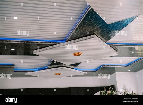 A Contemporary Ceiling Featuring Geometric Panels Integrated Lighting And A Sleek Modern