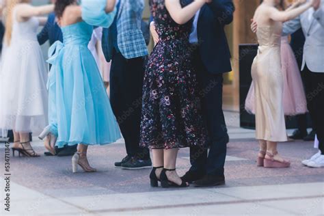 High School Graduates Dancing Waltz And Classical Ball Dance In Dresses And Suits On School Prom