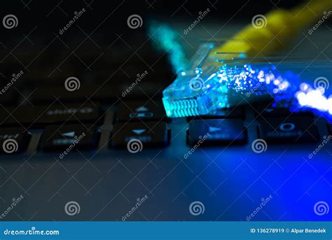 Yellow Internet Switch On Laptop Computer Keyboard Glowing Colorful Optical Fibres Stock Image