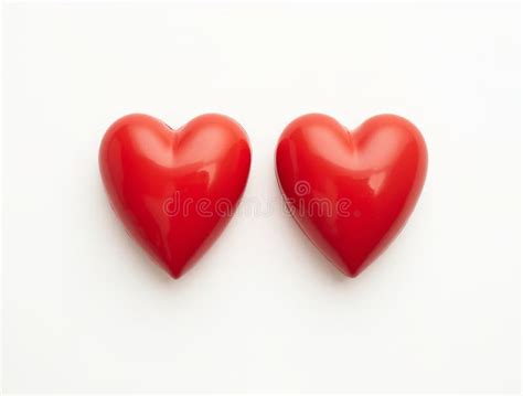 Two Identical Red Hearts Placed Symmetrically Side By Side On A White