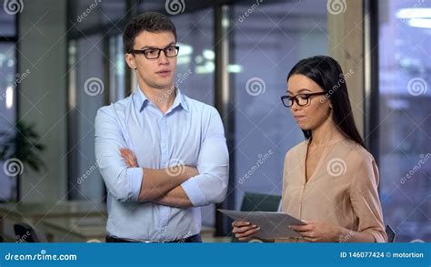 Nervous Secretary Holding Documents Feeling Scared Of Male Boss Office