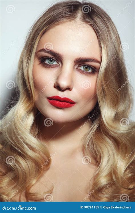 Beautiful Girl With Red Lipstick And Blonde Curly Hair Stock Image