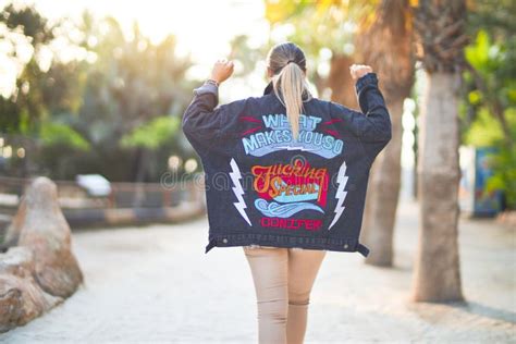Young Beautiful Woman Wearing Denim Jacket Standing Backwards At The Town Park Stock Image