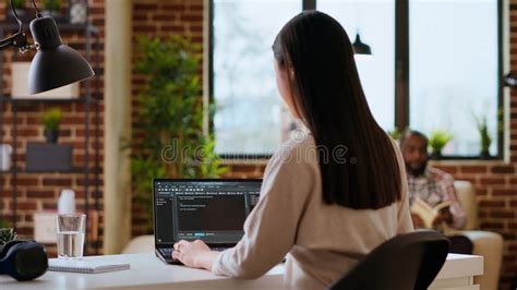 Professional Asian Software Engineer Is Working Remotely Typing Code On A Laptop Stock Image