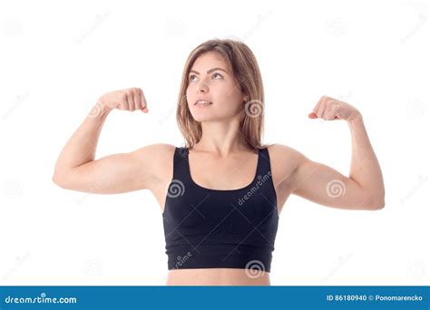 Athletic Girl In Black Top Shows Biceps On Hand Isolated White