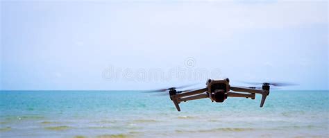 Drone With Digital Camera And Fast Rotating Propellers Flying Stock Drone With Digital Camera And Fast Rotating Propellers Flying Stock