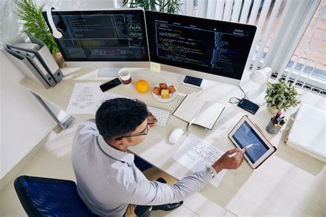 Premium Photo Software Developer Checking Calendar On Tablet Computer