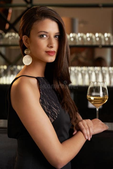 Beauty At The Bar An Attractive And Classy Young Woman Standing At The Bar Of A Upper Class