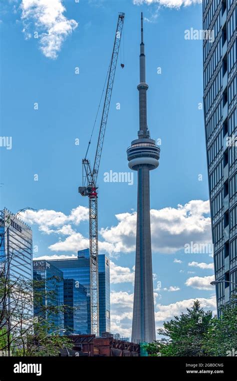 Construction In Toronto A Crane Is Seen Close To The Cn Tower Which Is