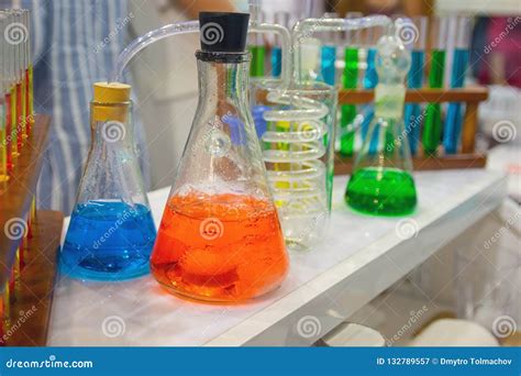 Laboratory Glassware With Solutions Of Different Colors On Table Stock