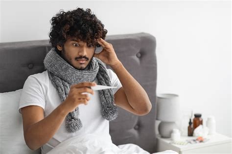 Premium Photo Hindu Guy With Scarf Around His Neck Checking Body Temperature