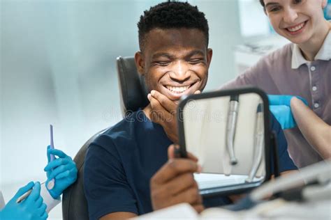 African American Male Client Satisfied With Stomatologist Work Stock