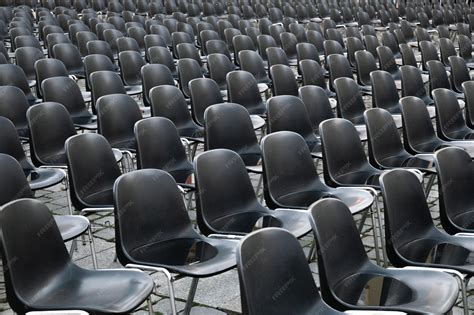 Premium Photo A Lot Of Black Empty Plastic Chairs Stand On The Street
