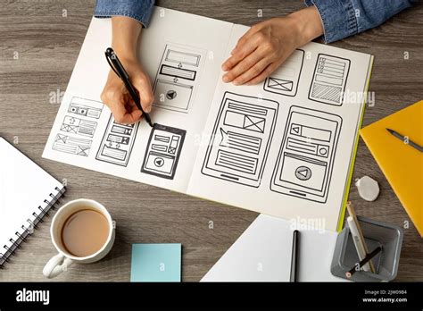 UI Designer Sketches The User Interface Of A Web Application For A Mobile Phone A Developer