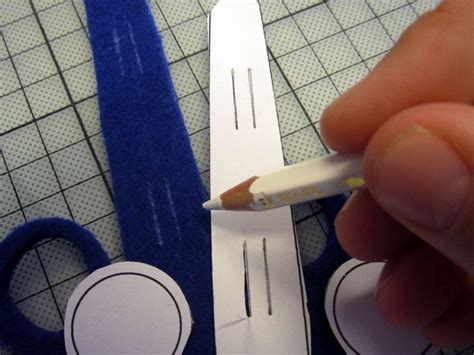 Someone Is Holding A Pencil And Cutting Out The Shape Of A Paper