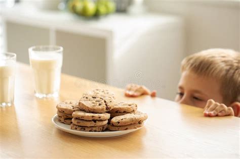 A Boy Is Peeping At An Appetizing Stack Of Freshly Baked Chocolate