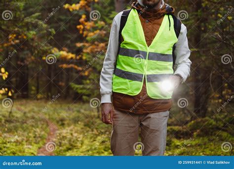 Male Volunteer Of The Search And Rescue Team Dressed In A Signal Vest
