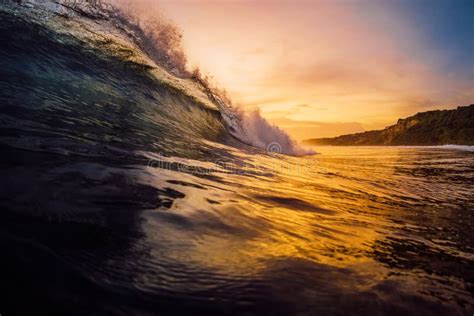 Perfect Surfing Wave With Warm Sunset Tones In Ocean Stock Photo