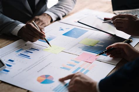 팀워크 프로세스 비즈니스 팀은 계산기를 사용하여 문서 그래프 데이터 사무실의 책상에서 통계적 비즈니스 이익 성장률의 수를