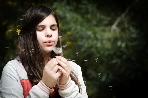 Premium Photo Young Woman Blowing Dandelion