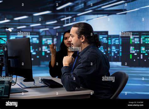 Technicians Reconfiguring Server Room Facility To Optimize It For Data