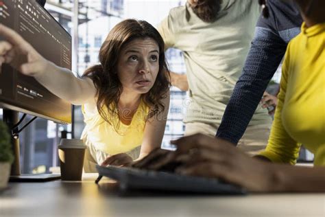 Man Fixing Coding Mistakes Assisted By Colleagues Doing Brainstorming