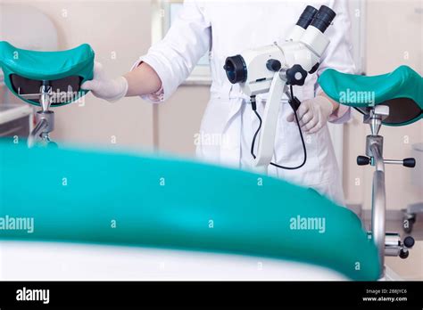 Gynecological Room With Chair And Equipment Hands Of Female Doctor With Tools For Examination