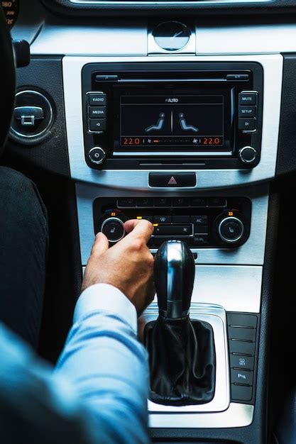 Premium Photo Driver S Hand Adjusting Audio Button In Car