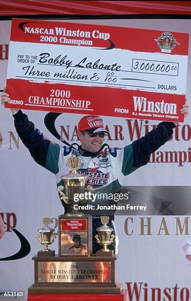 Driver Bobby Labonte Poses With His Winning Check After Winning The