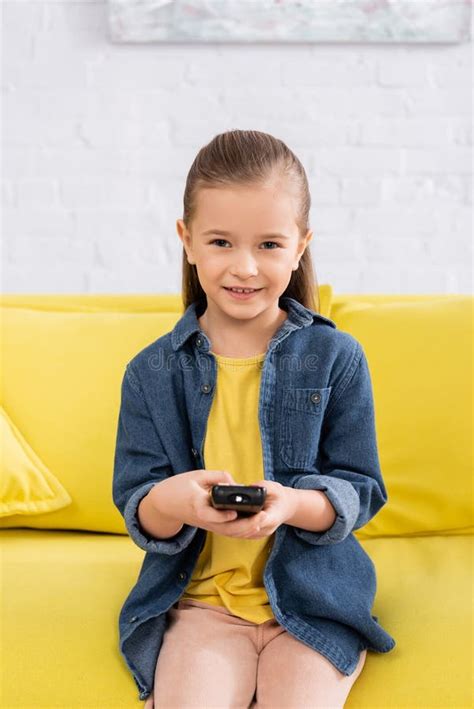 Smiling Girl With Remote Controller Sitting Stock Image Image Of Yellow Cheerful 220868555