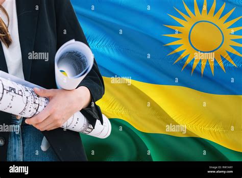 Rwandan Architect Woman Holding Blueprint Against Rwanda Waving Flag